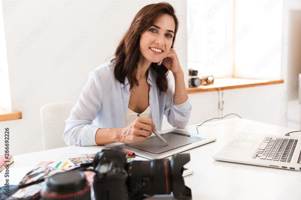 Beautiful young woman photographer working at her office Stock Photo ...