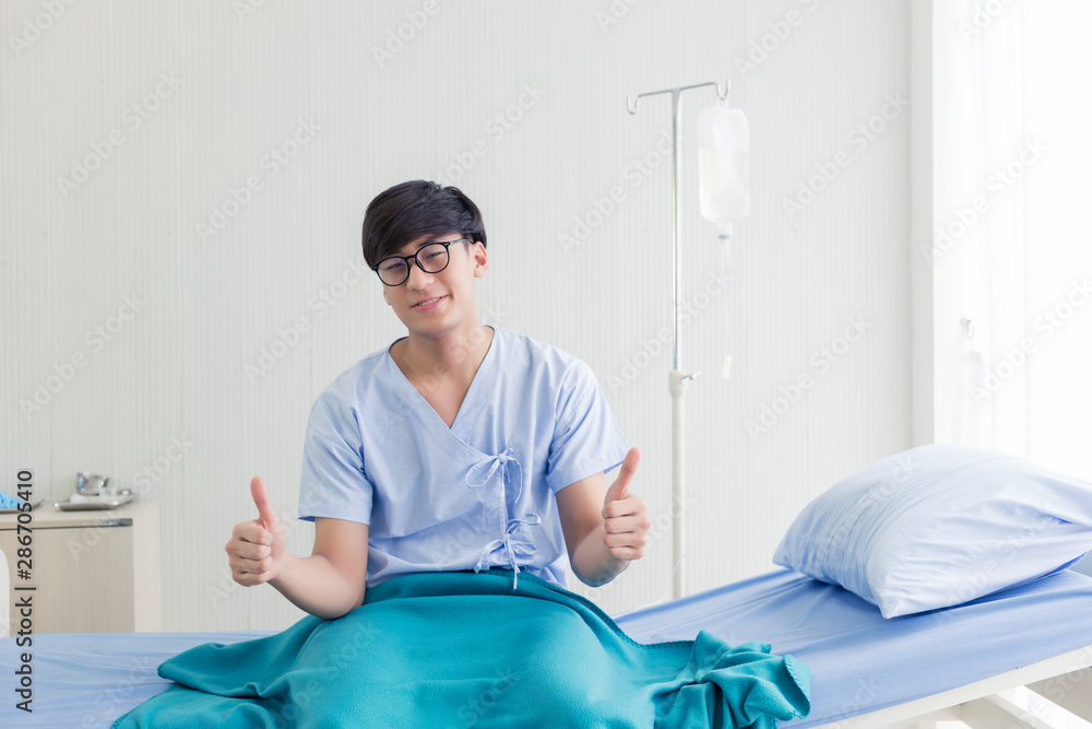 Young Asian teenage patient man showing thumbs up with happy smiley ...