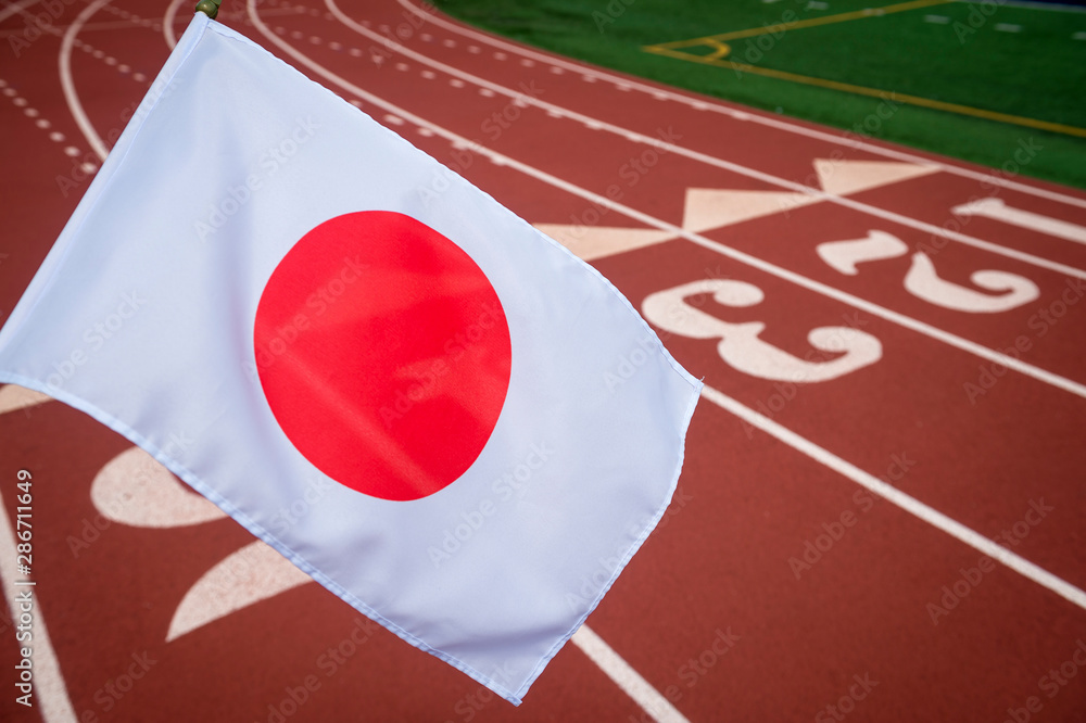 Bright sunny view of a Japanese flag flying in front of the numbered ...