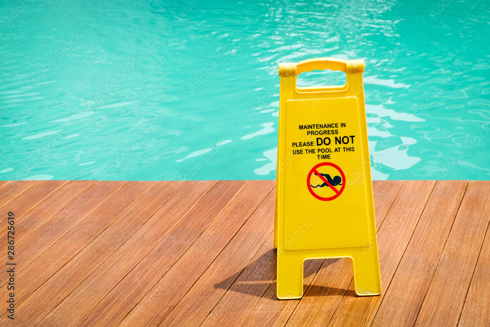 warning sign at the edge of swimming pool Stock Photo | Adobe Stock