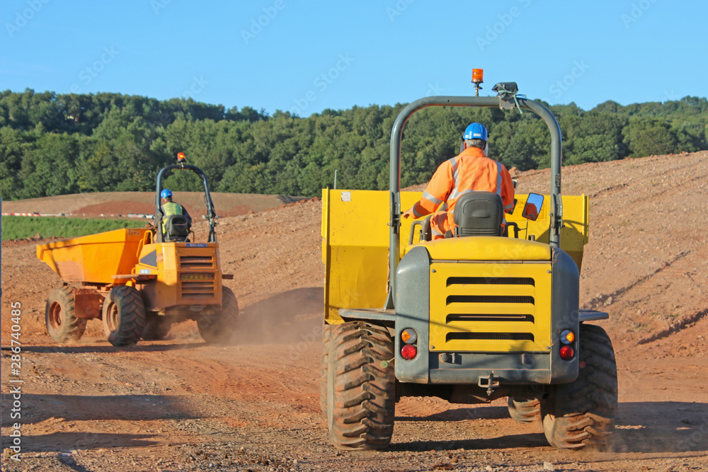 Dump trucks on a road construction site Stock Photo | Adobe Stock