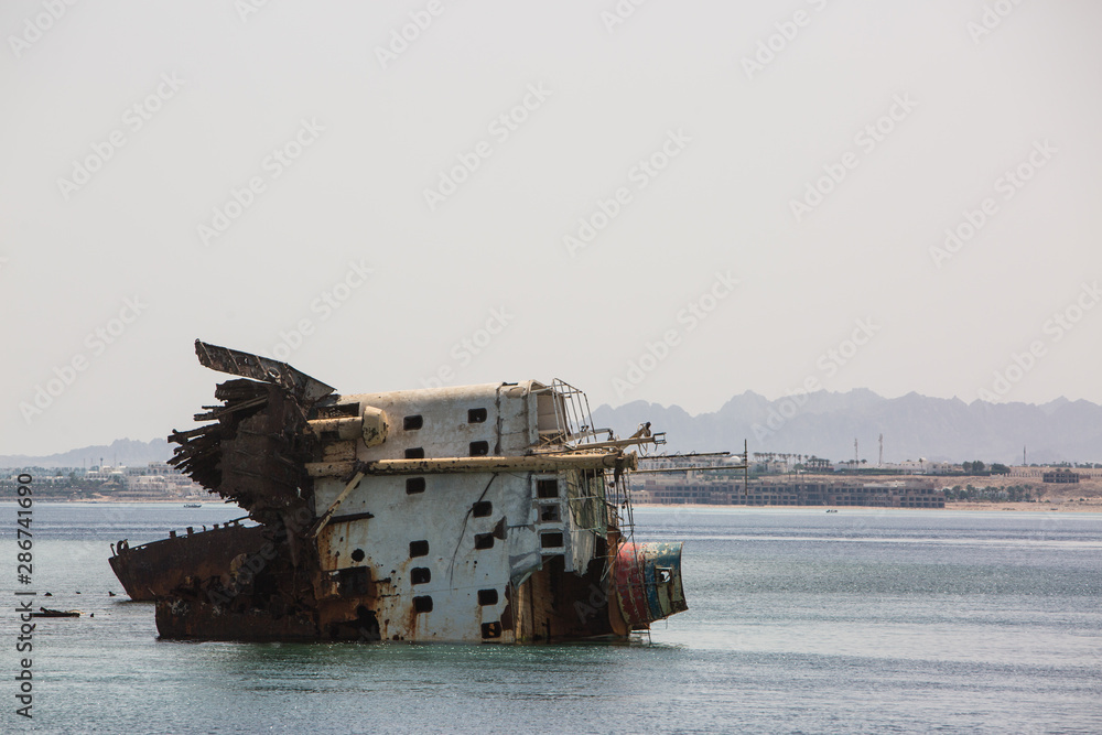 View of a old sunken rusty ruined ship on a shoal in sea Old seagoing ...