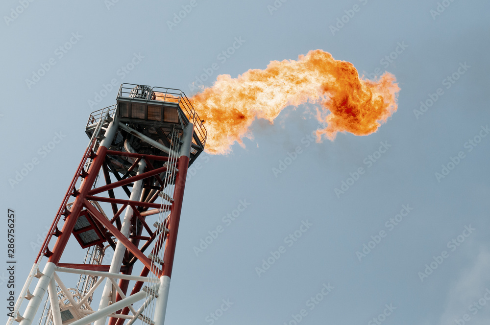Flare boom nozzle and fire on offshore oil rig Stock Photo | Adobe Stock