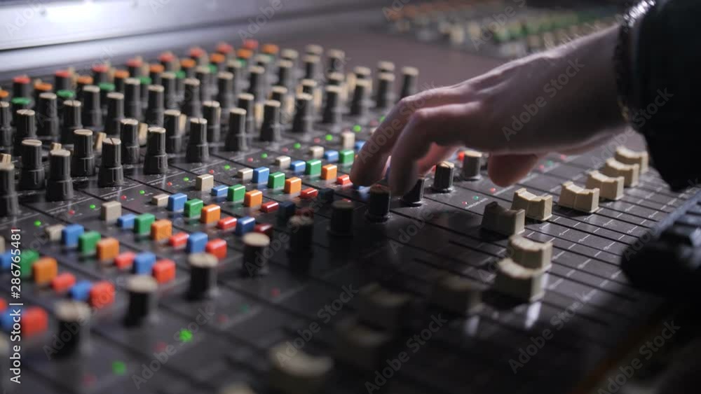 Close up of digital audio workstation with mixing console. Hand of ...