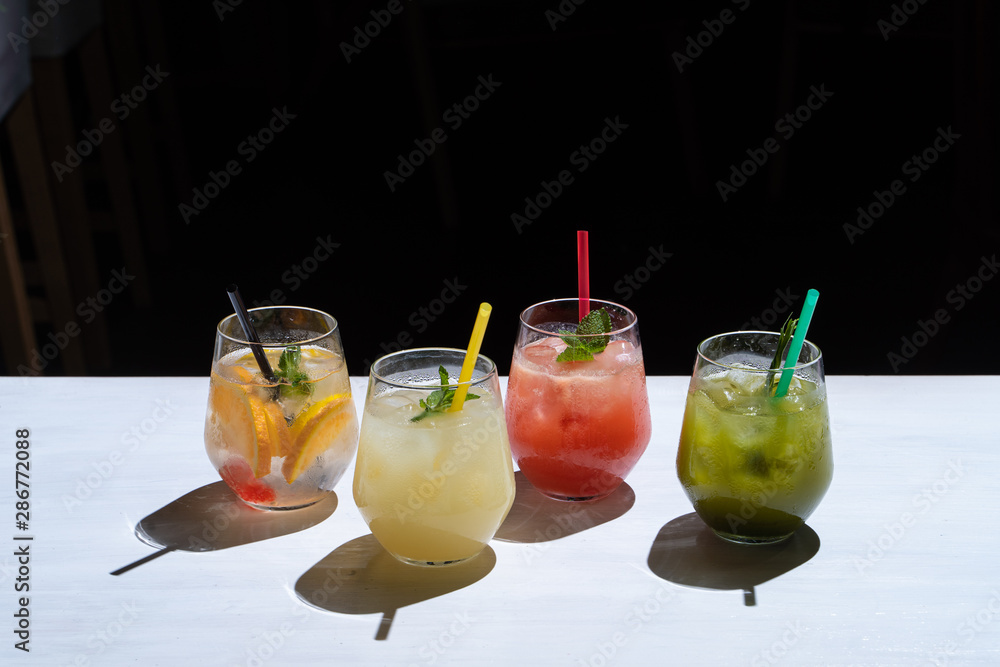 Side view of various of refreshing summer lemonades: classic lemon soda ...