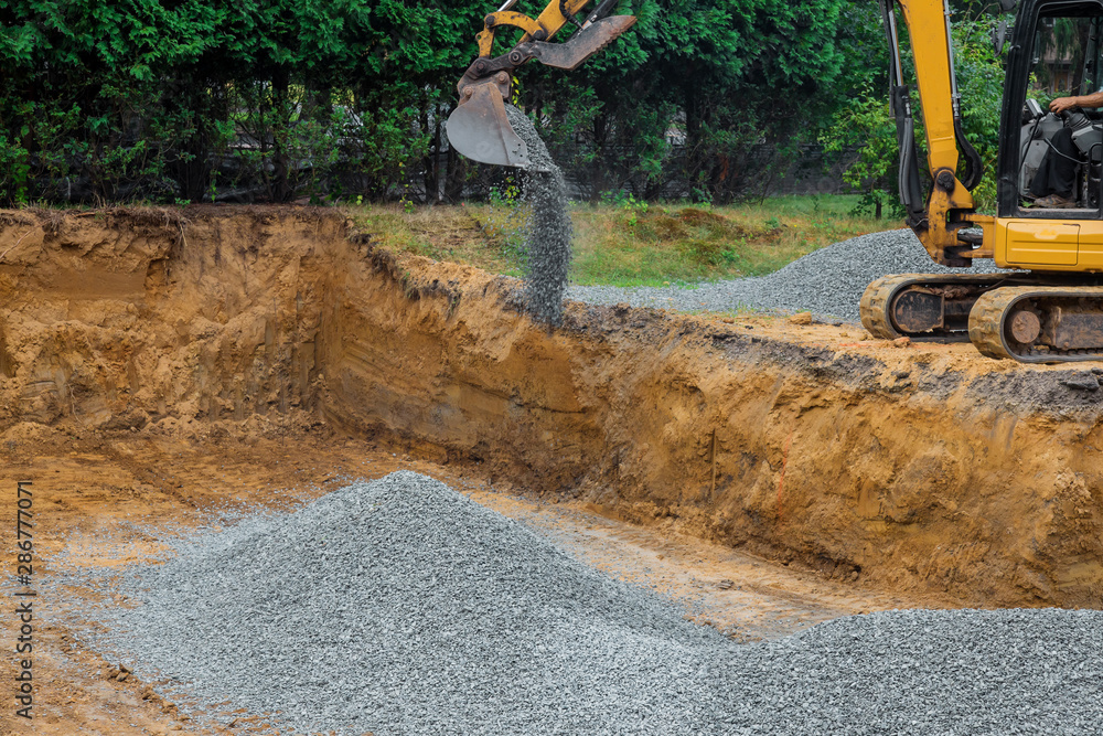 Backfilling trench for the stones gravel at construction site in ...