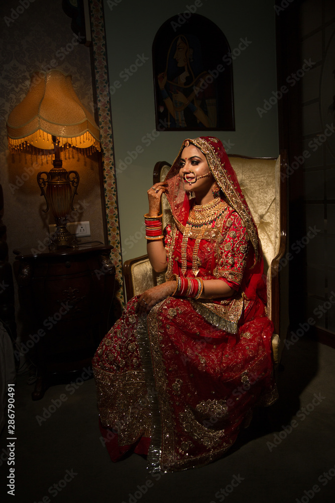 Beautiful traditional Indian girl sitting on sofa like a princess ...