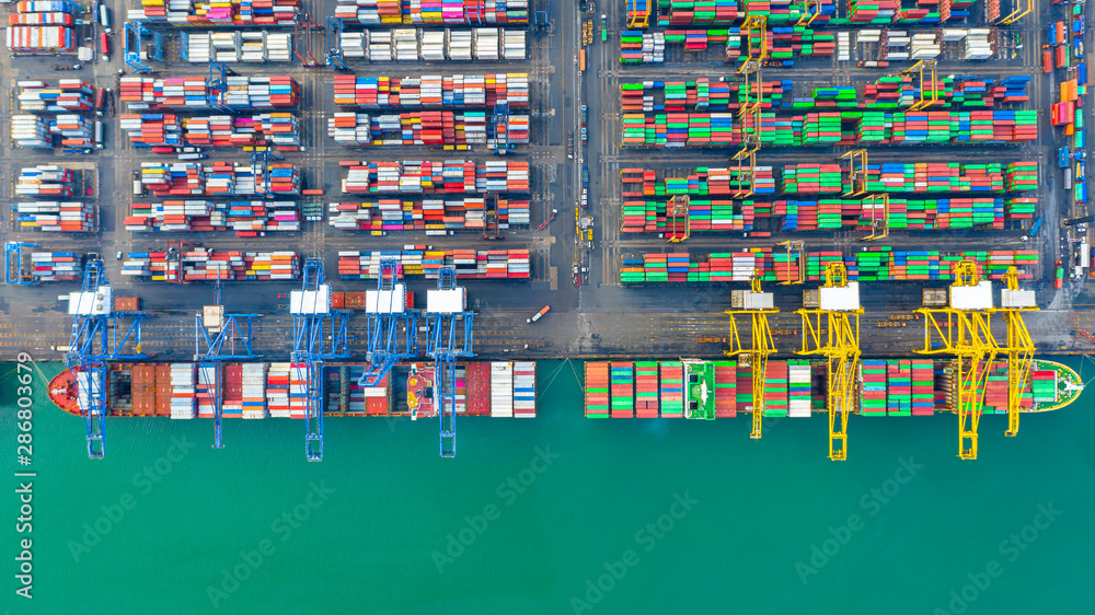 Container ship loading and unloading in deep sea port, Aerial top view of business logistic ...