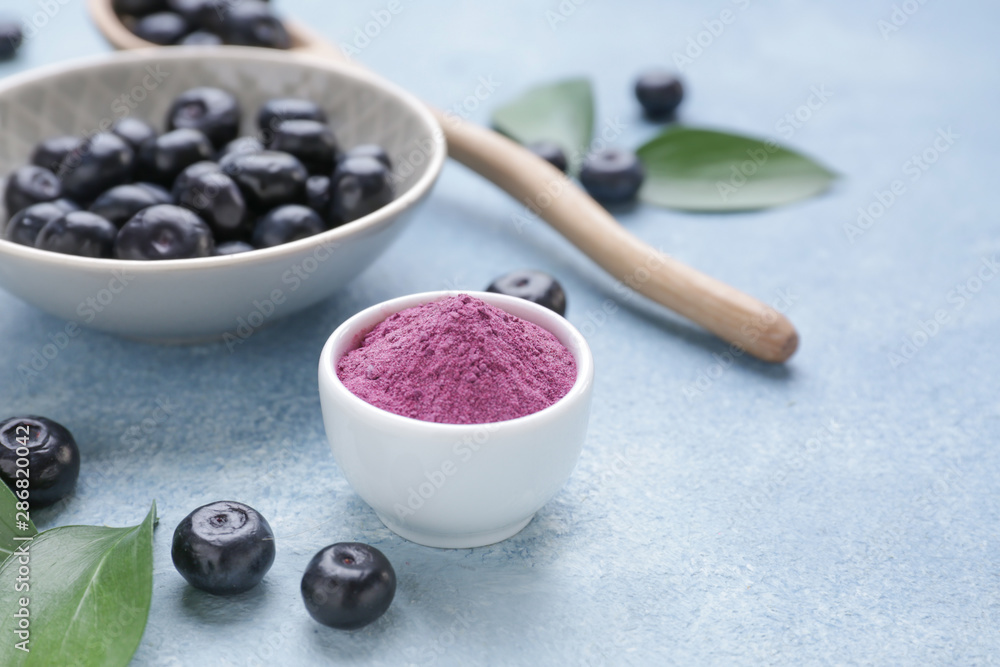 Acai berries with powder on color background Stock Photo | Adobe Stock