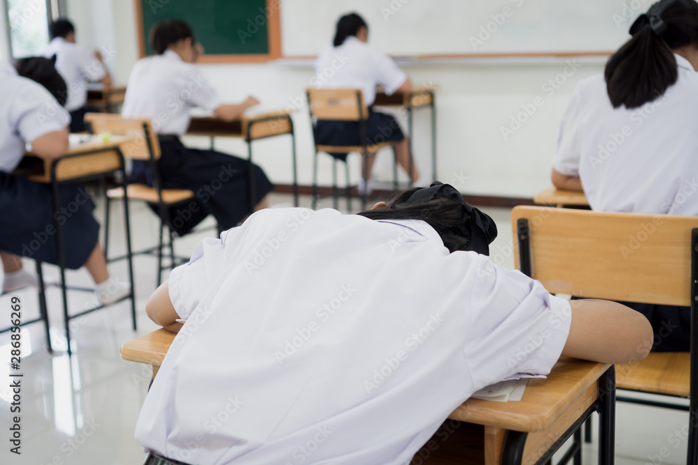 Blurred of Asian girl student tired, lazy boring and sleeping on table ...