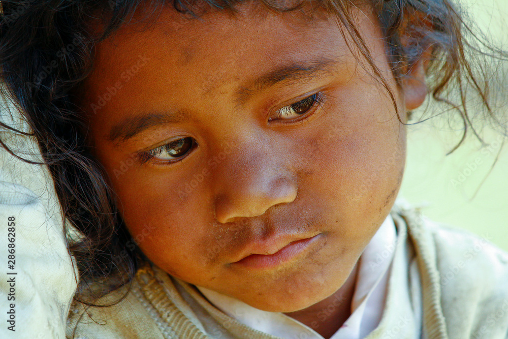 Poverty, portrait of a poor little African girl lost in deep thoughts ...