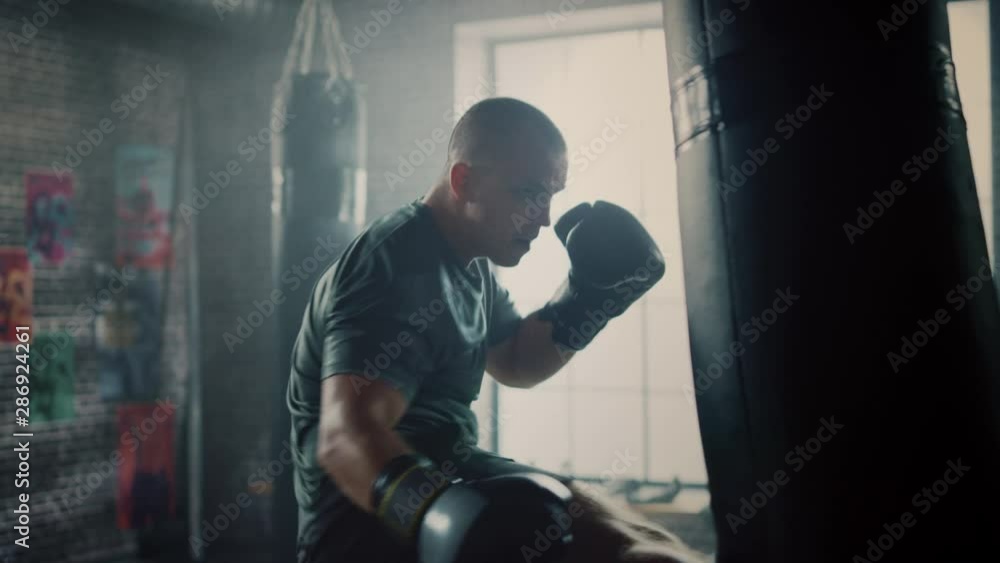 Strong and Handsome Male Kickboxer is Working Out in a Loft Gym with ...