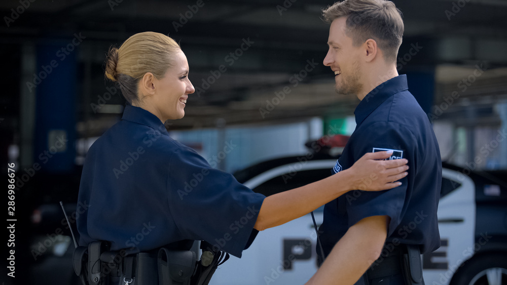 Police mates greeting each other standing near patrol car, ready to ...