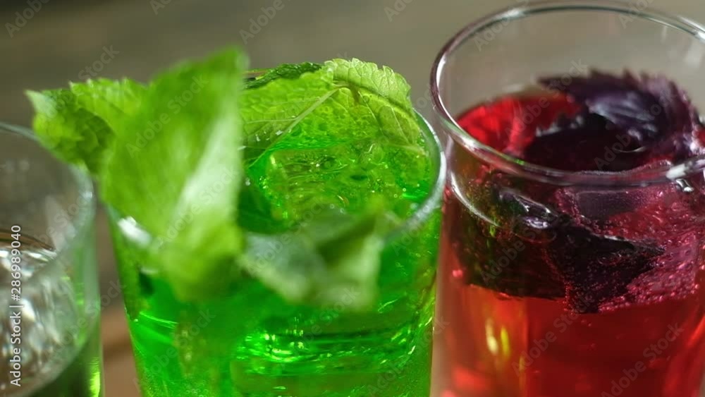 panoramic close-up of refreshing cocktails. Green drink with mint leaf ...