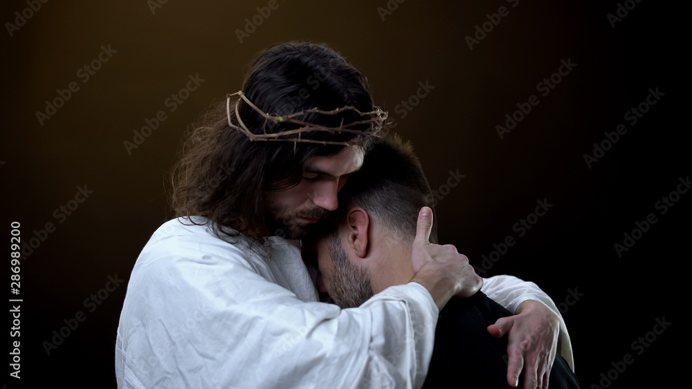 Savior in crown of thrones hugging desperate male, religious peace ...