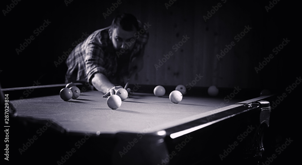 A man with a beard plays a big billiard. Party in a 12-foot pool ...