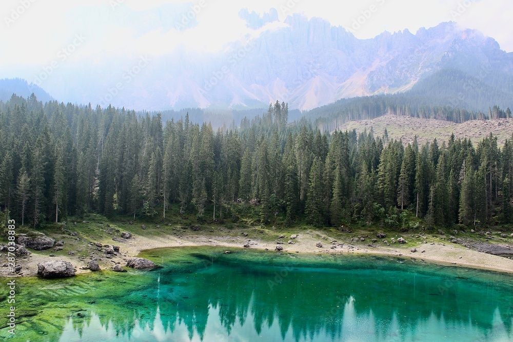 Lake Carezza, the small mountain lake is famous for the dark green ...