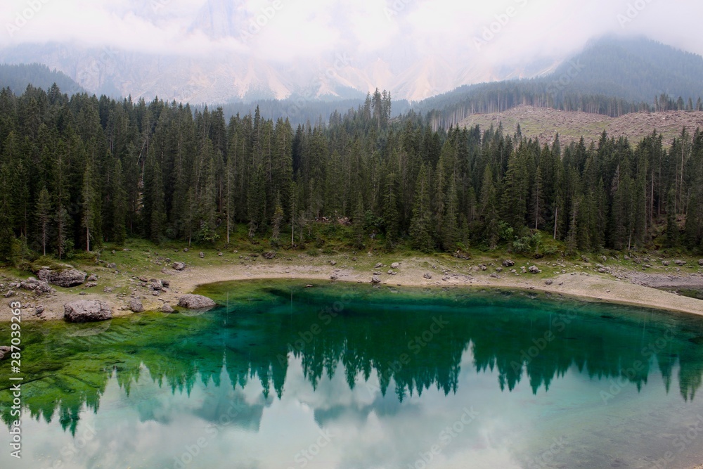 Lake Carezza, the small mountain lake is famous for the dark green ...