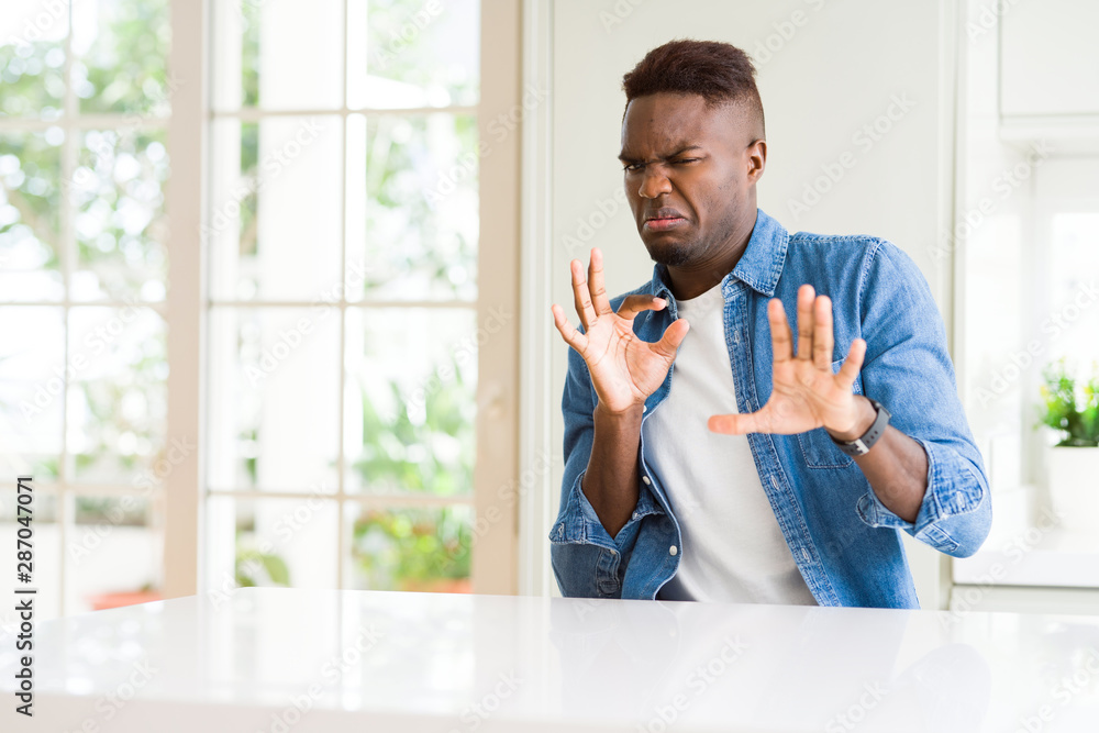 Handsome african american man at home disgusted expression, displeased ...