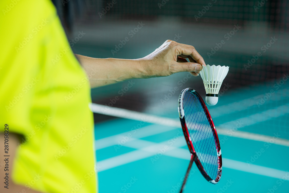 Hands of woman Badminton player holding shuttlecock and racket ready to ...
