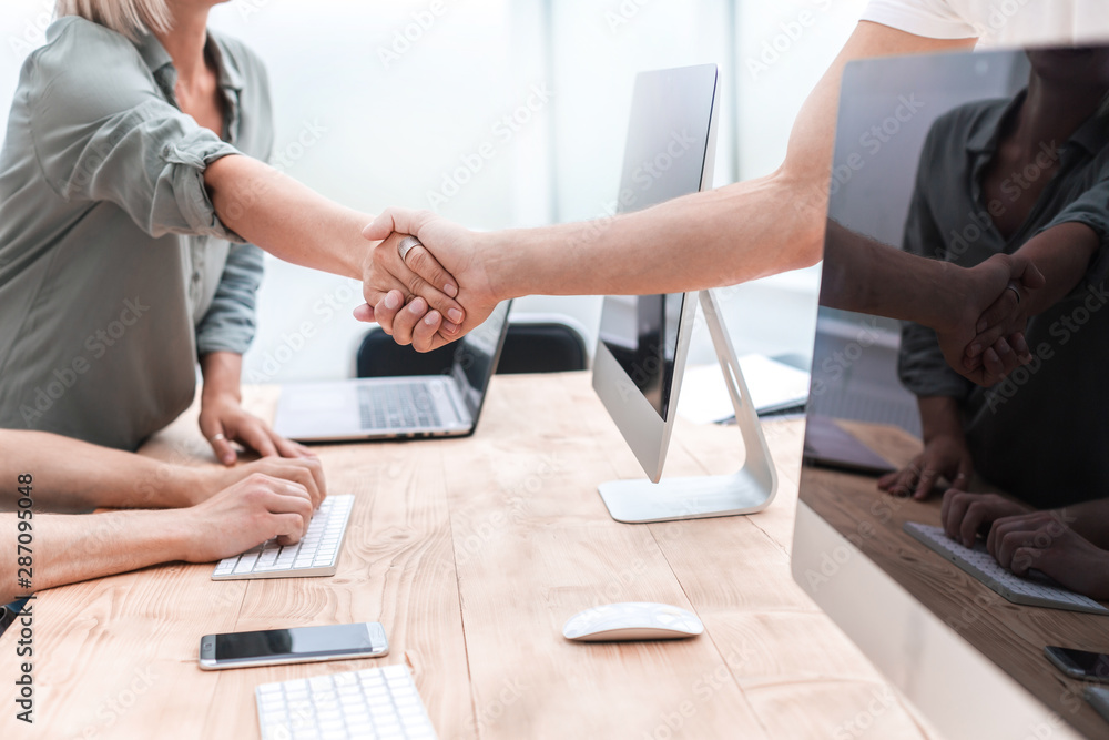 close up. Manager welcomes the client with a handshake Stock Photo ...