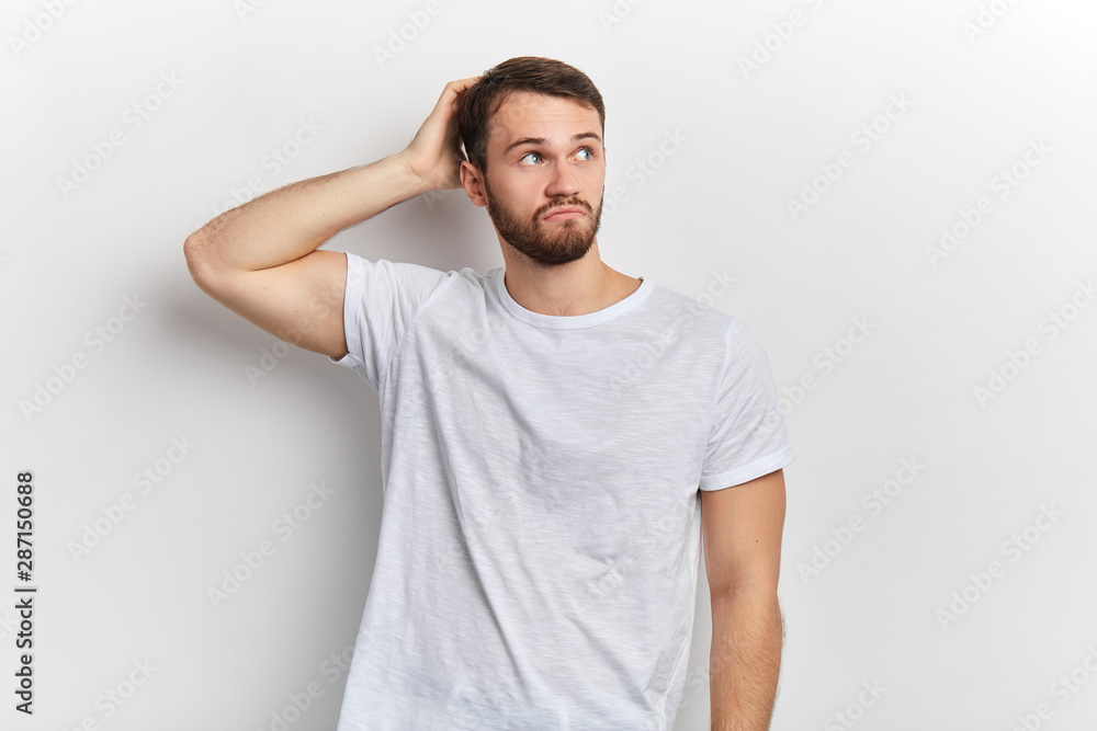 serious man scratching head, thinking deeply about problem trying to ...