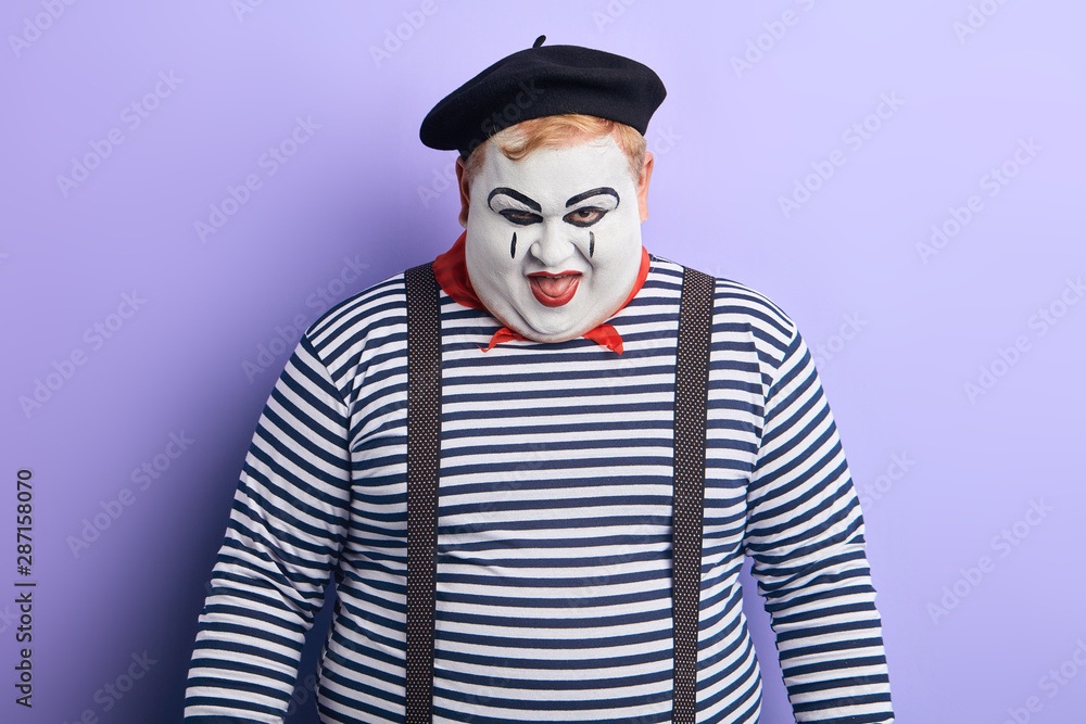 cruel ugly fat clown laughing at the camera, expressing negative ...