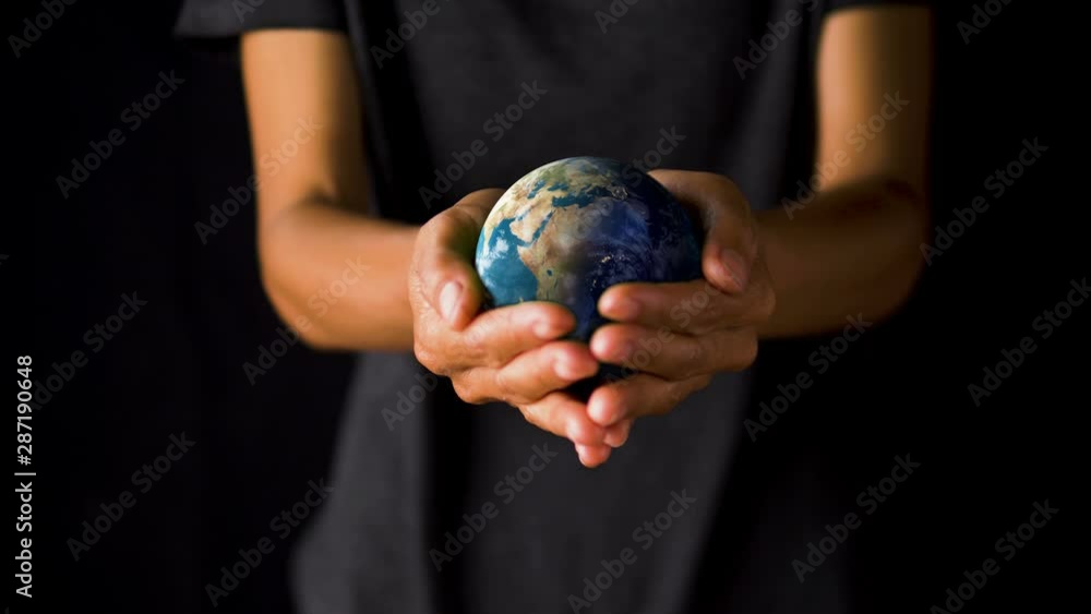 Female hand holding a realistic Earth. Holding the world in your hand ...