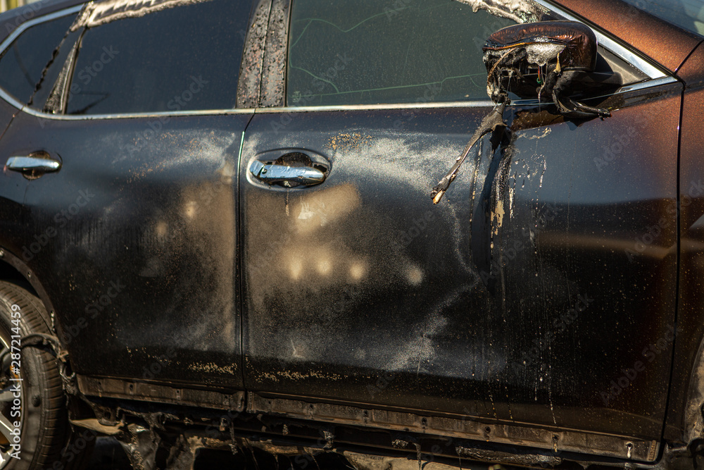 Car after the fire. Burned out car with an open hood. Arson, burnt car ...