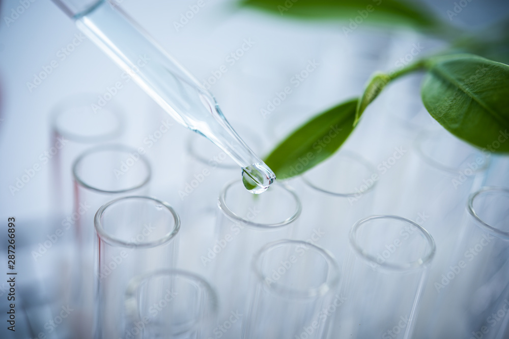 Dropper over test tube dropping sample chemical into sample herbal ...