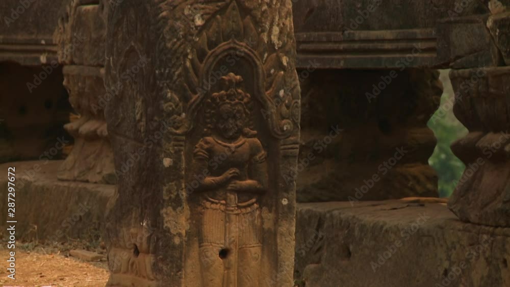 A daylight closeup view of a carved stone monolith in the entrance of ...