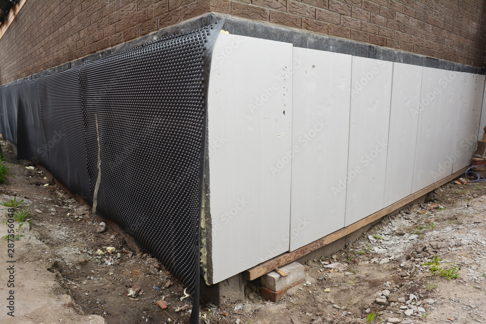 Foundation insulation and waterproofing. House foundation wall ...