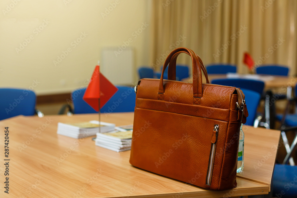 Elegant brown briefcase, business case on a desk in conference room ...