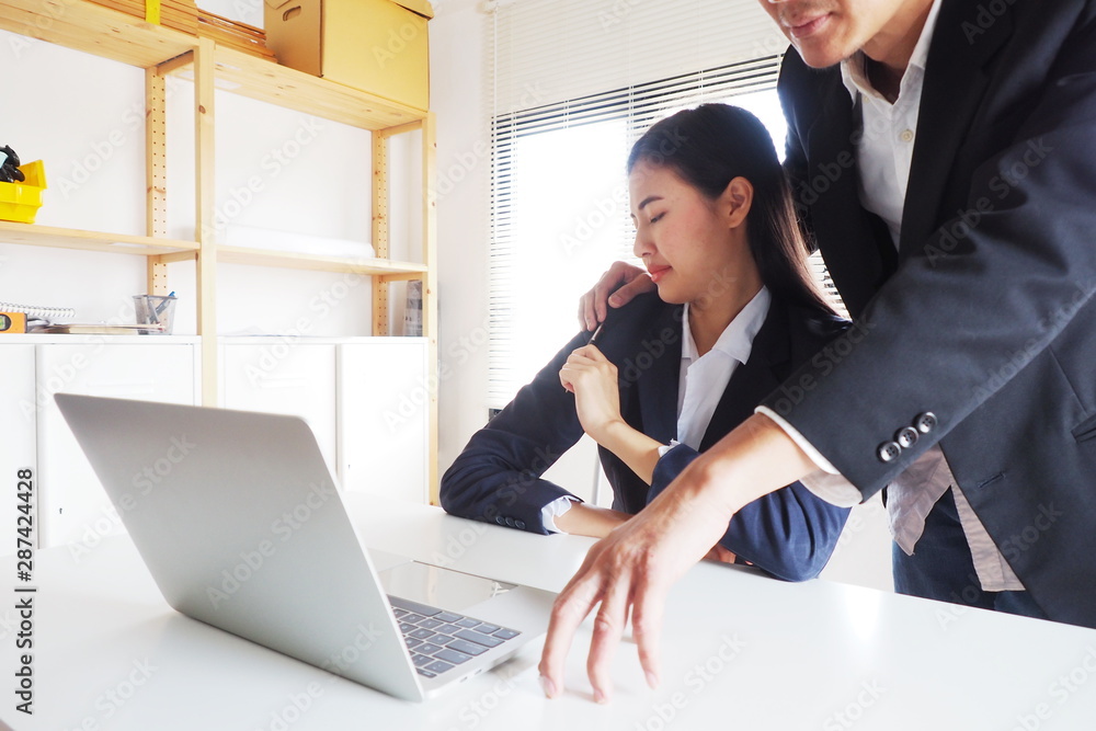 Asian Male Manager Using His Hand Touching His Female Colleague In The