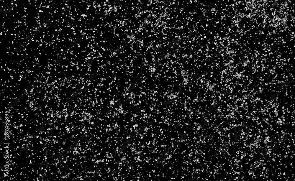 Sea salt grains crystals isolated on black background and texture, top ...