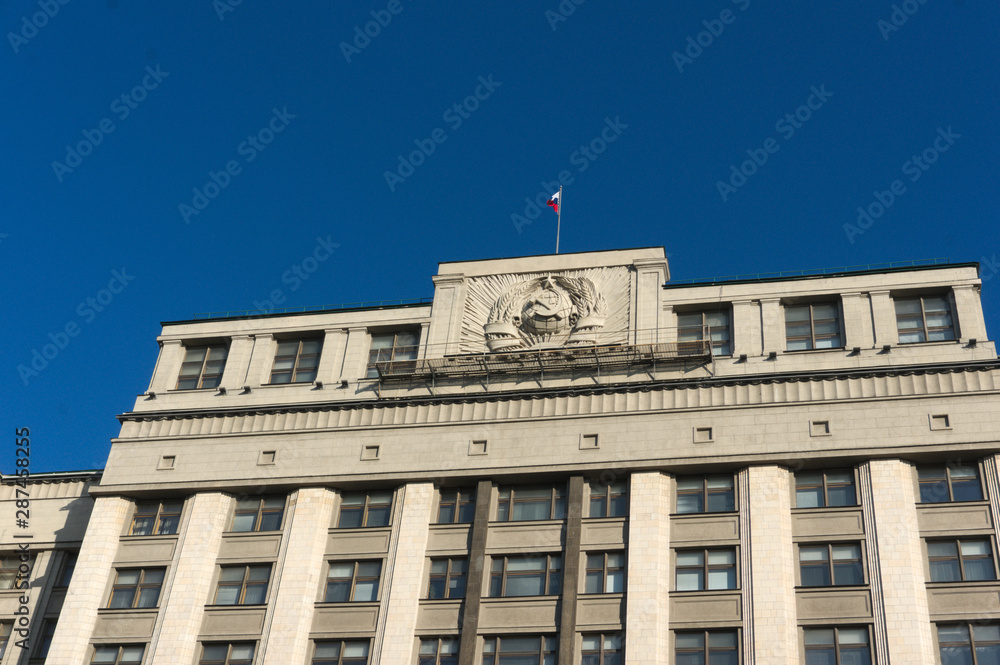 Russian flag and the Soviet coat of arms on the Parliament building in ...