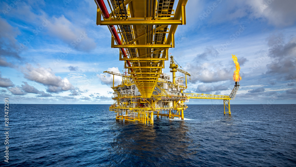 Offshore oil and gas platforms are in the process of releasing gas to ...