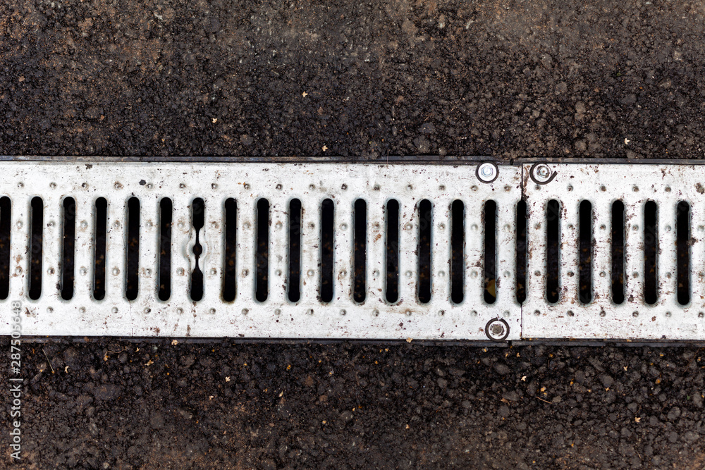 Water drain, metal part and red pavement texture. Stock Photo | Adobe Stock