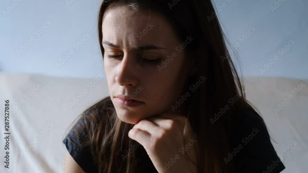 Close up desperate woman sit on sofa looking away feel depressed ...