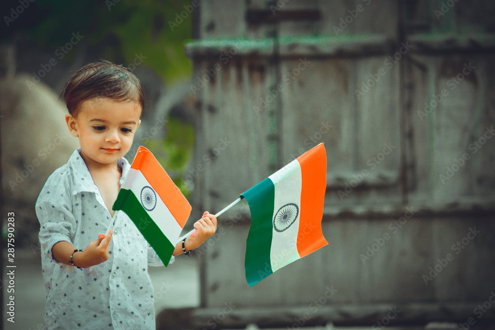 Indian child with indian flag in his hand on the day of independence or ...