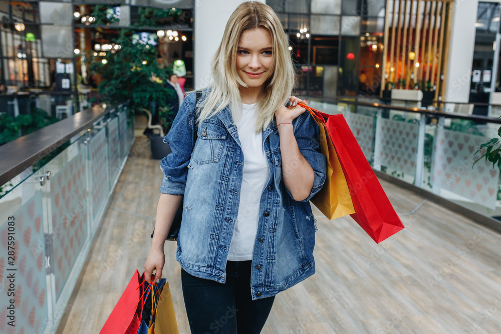 Commerce and shopping season. Beautiful girl in a denim jacket with ...