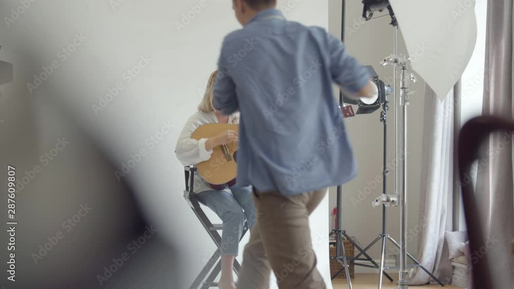 Backstage of the photo shoot. Famous professional photographer taking ...