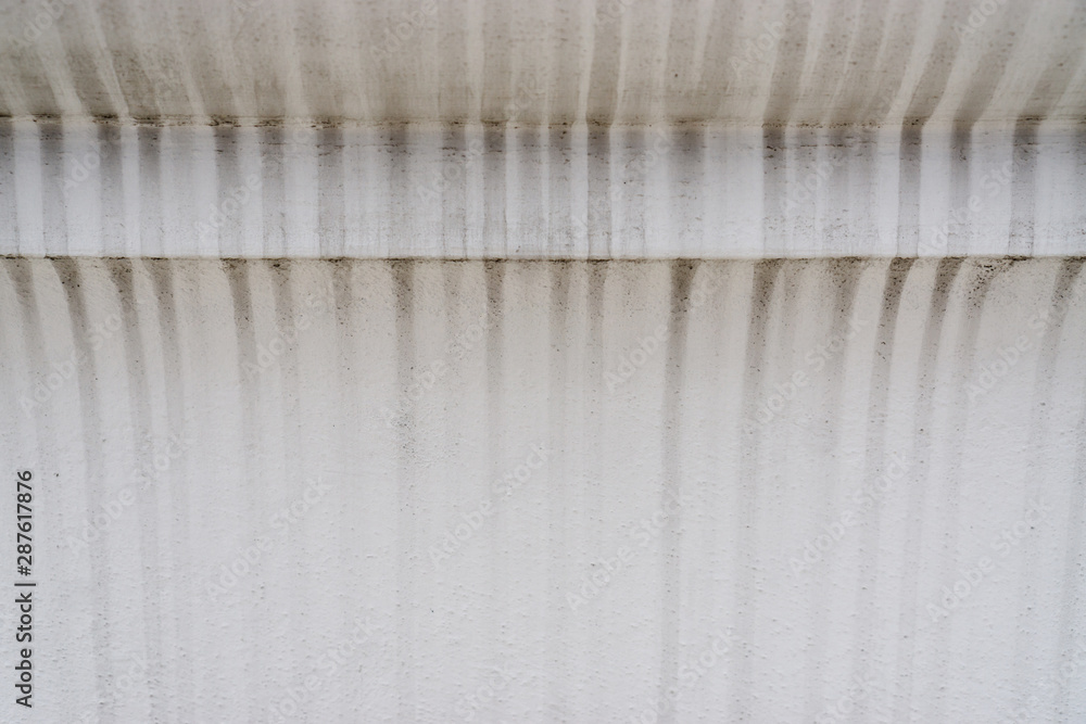Texture of concrete wall with dark water marks running vertically down ...