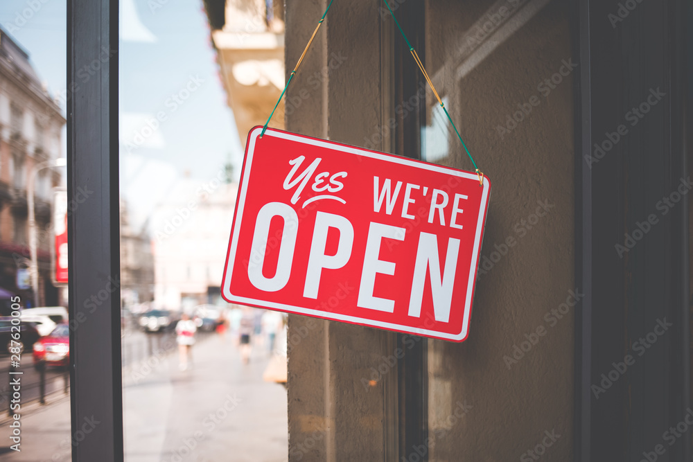 yes we're open sign on the glass of the doors in store. welcome sign at ...
