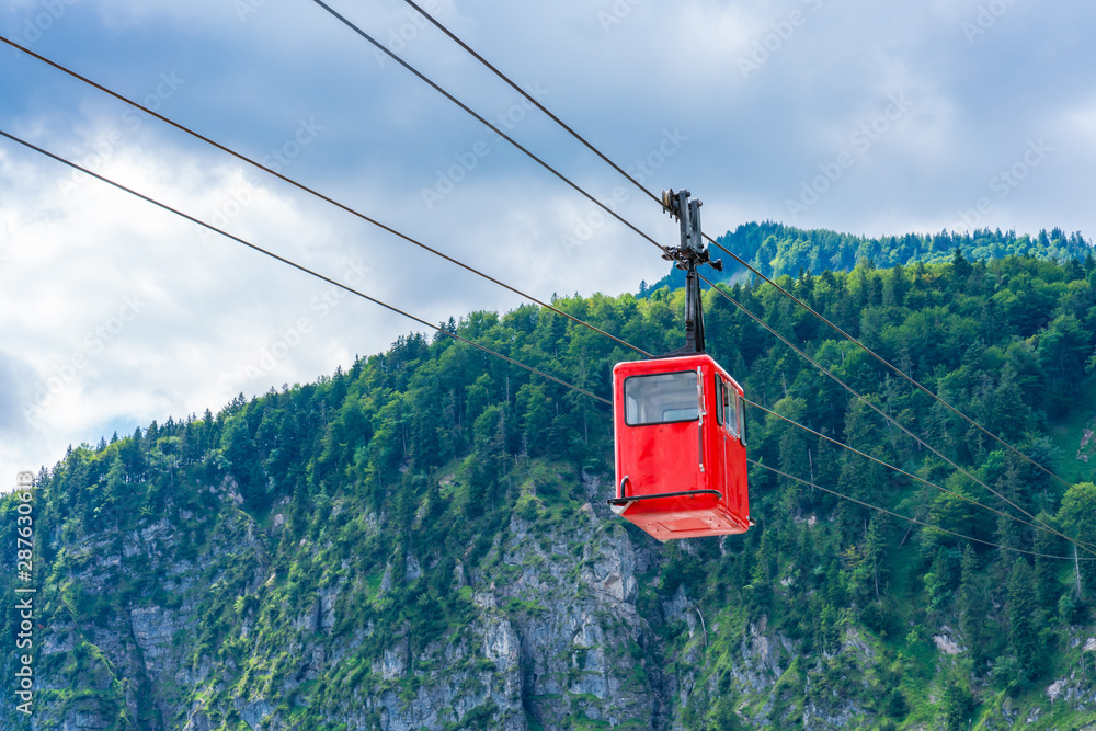 Red Seilbahn cable car gondola against Zwolferhorn mountain in St ...