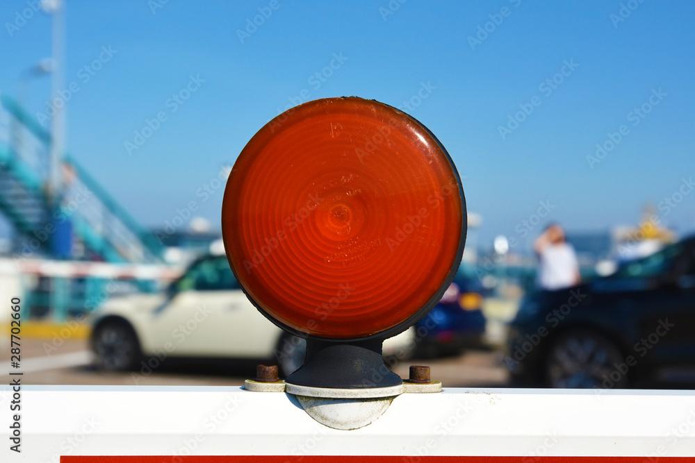 Red round traffic warning light on barrier in front of blue sky Stock ...