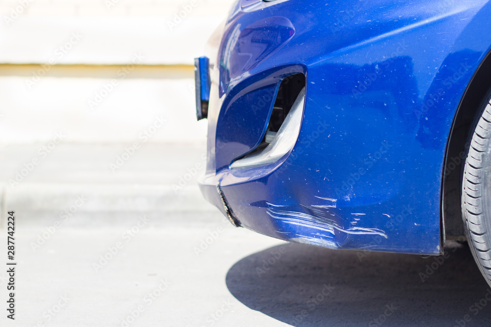 Damaged front bumper of a blue car close-up. scratches on the surface ...