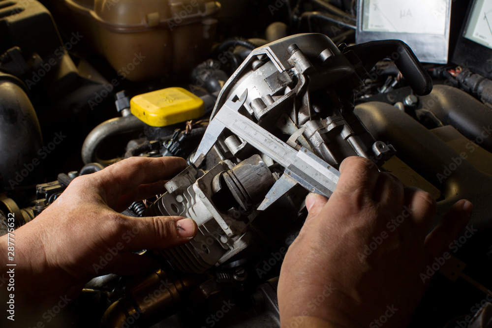 Hands measure the piston of a car engine using a ruler Stock Photo ...