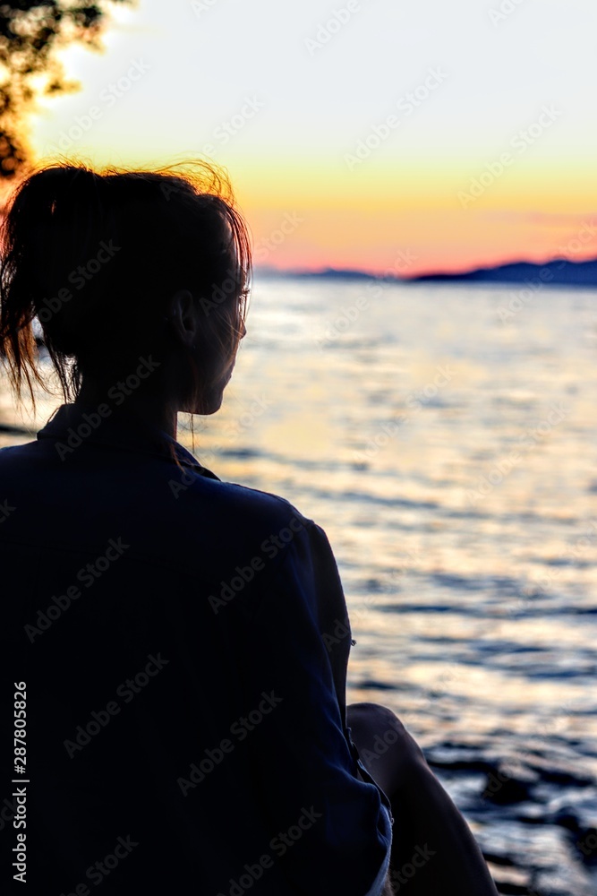Girl Sitting On Beach Sunset