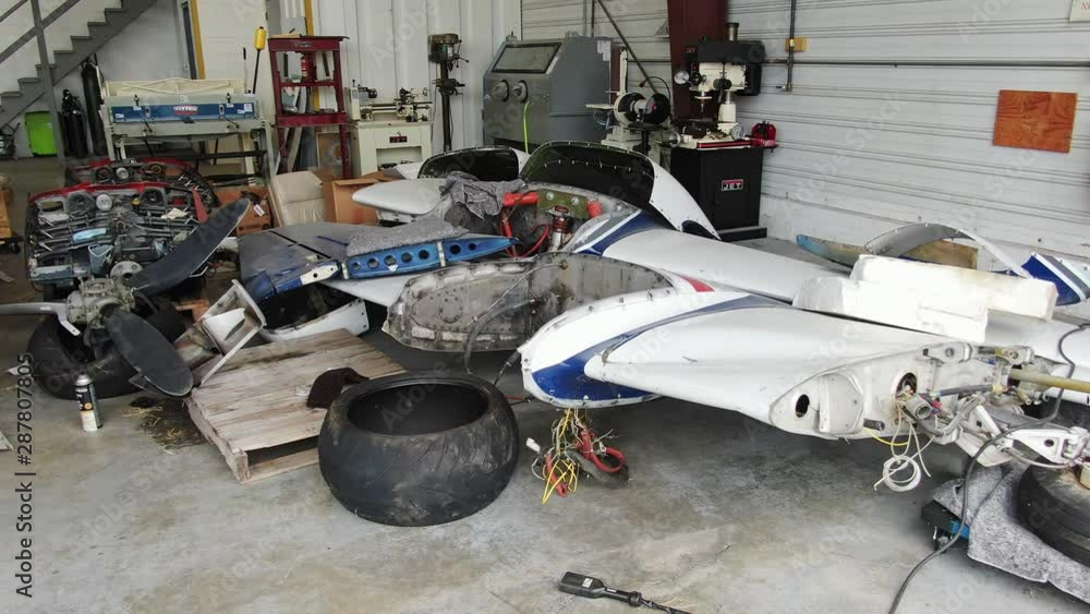Piper twin engine airplane in repair hangar after it was damaged in an ...
